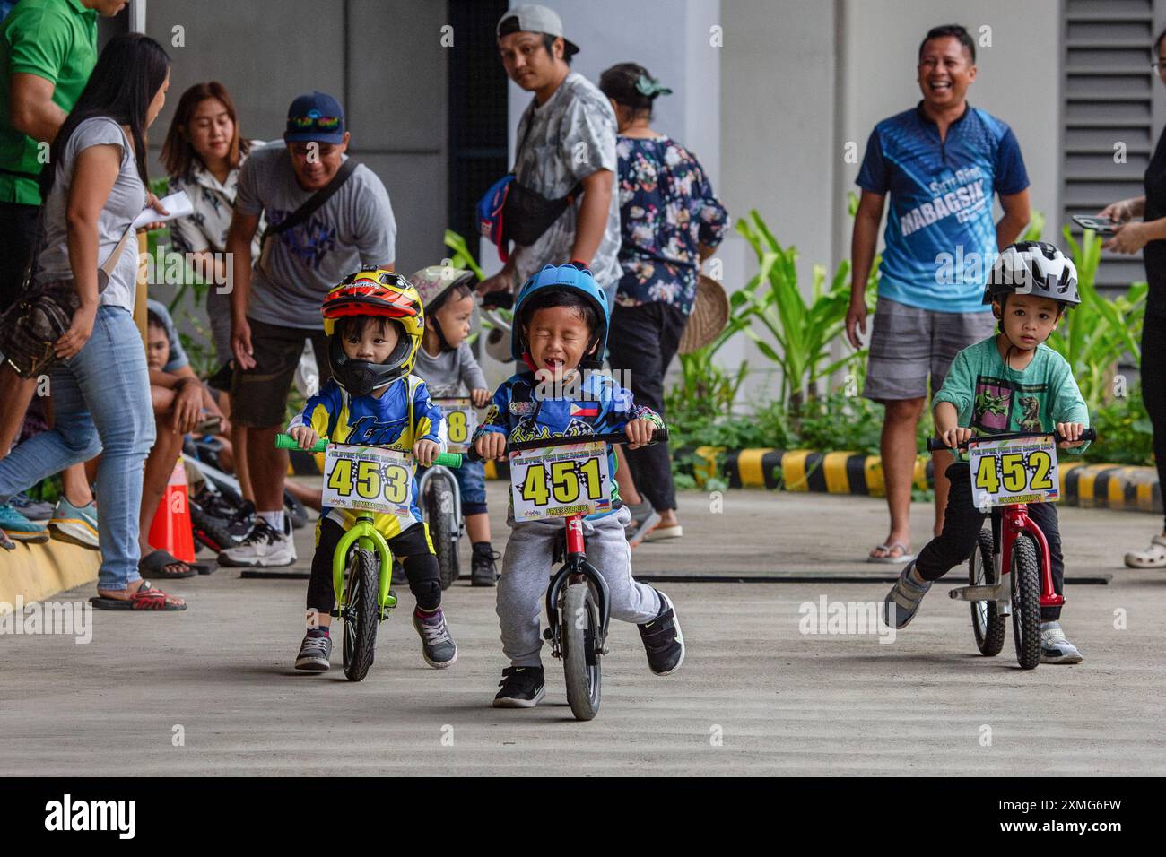 Iloilo City, Philippines. 28th July, 2024. Children participate at a push bike race for kids ...