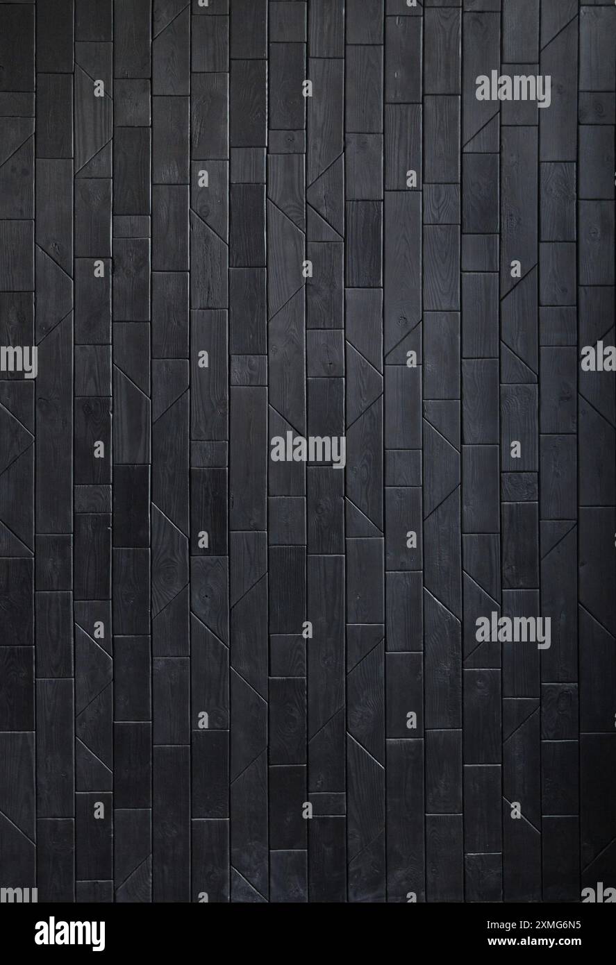 Minimalist dark background of charred black boards laid side by side ...