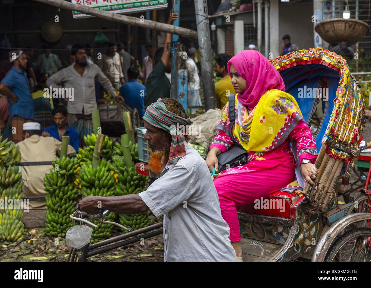 Woman sit in a rickshaw at vegetables and fruits morning market, Dhaka ...