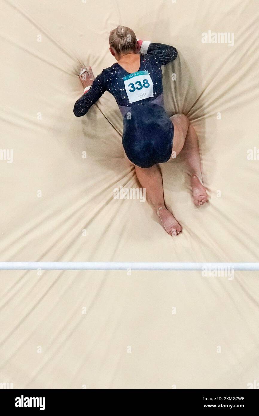 Ruby Evans, of Great Britain, falls on the uneven bars during a women's ...
