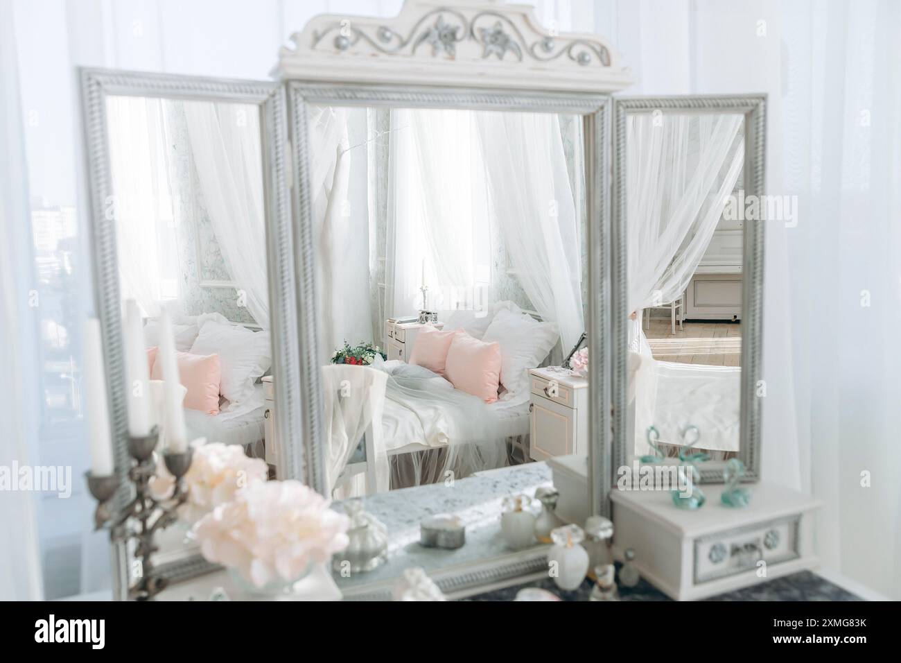 Elegant vanity setup featuring ornate mirror reflecting white canopy ...