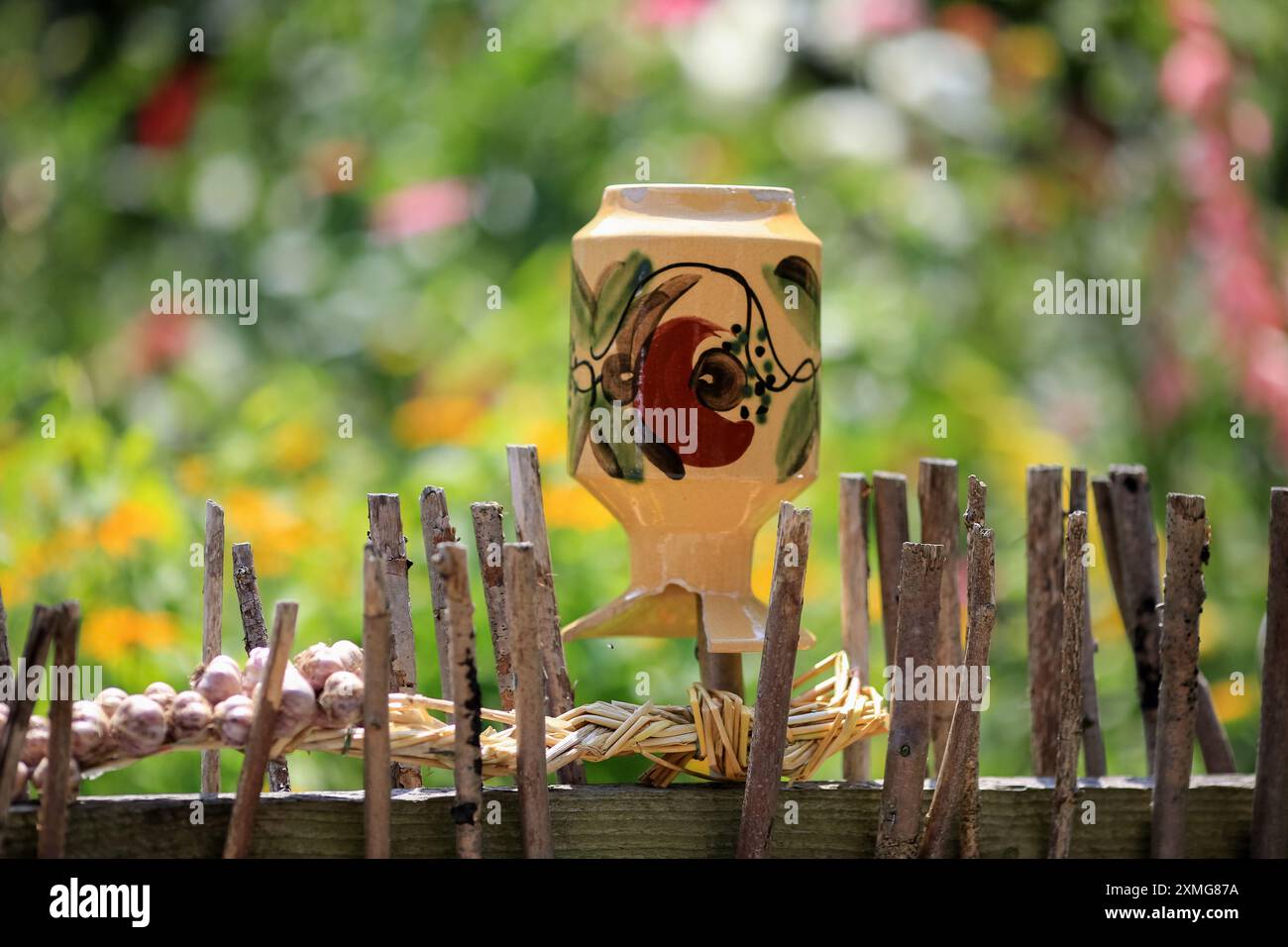 Ceramic pot installation on the wooden fence, closeup Stock Photo - Alamy