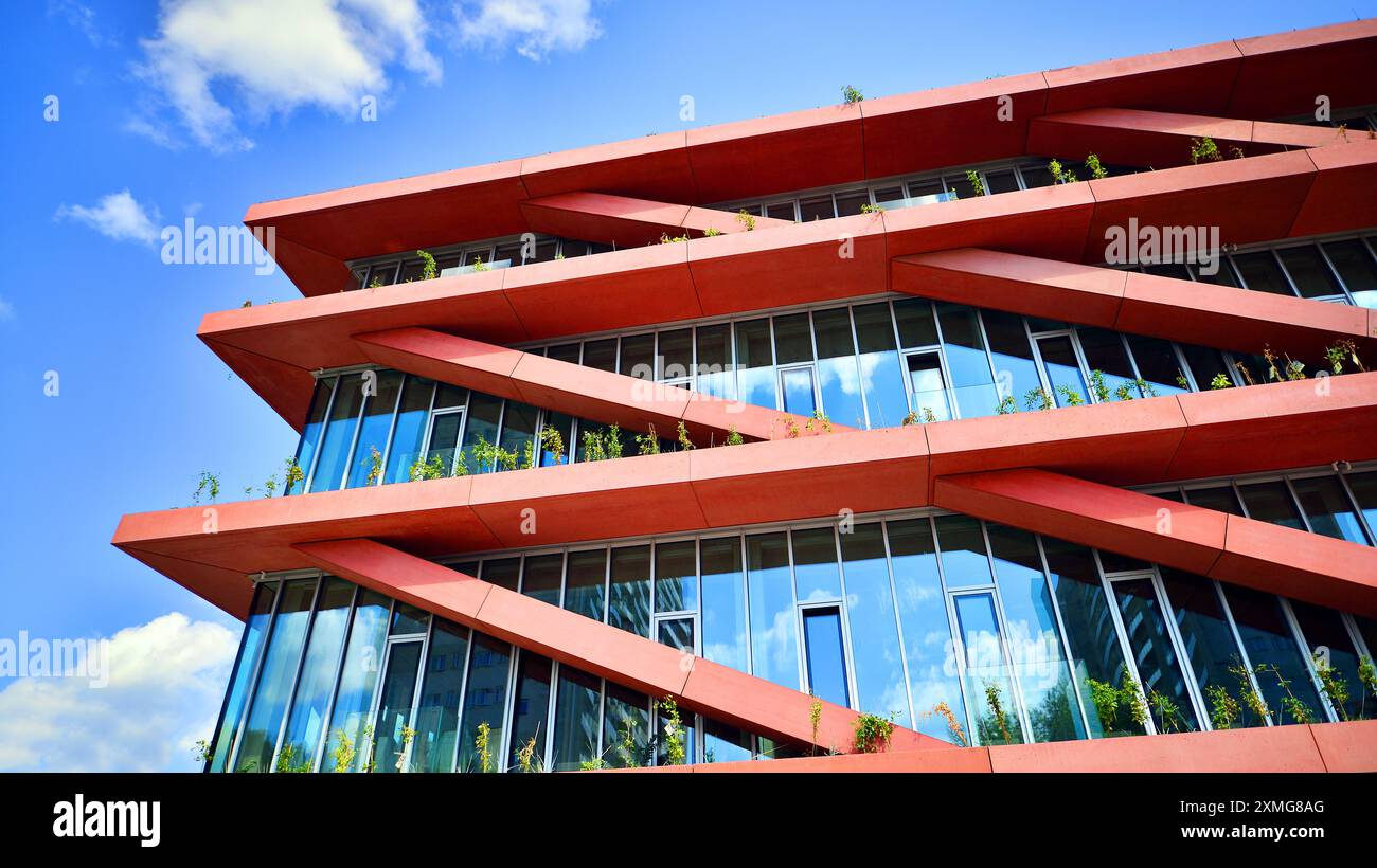 Modern office building with glass facade on a clear sky background ...