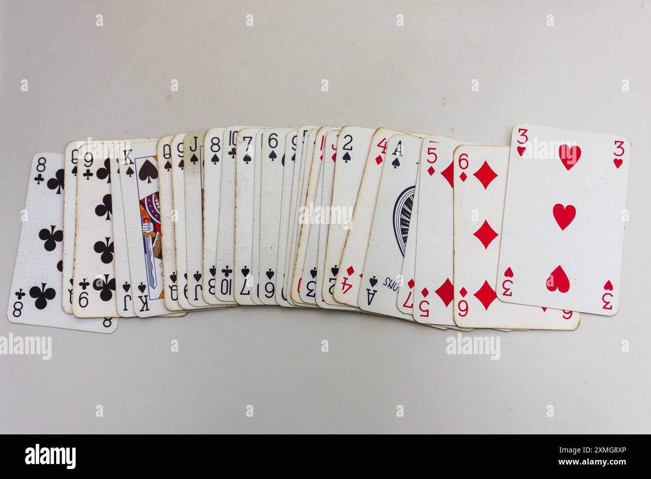 some playing cards on a table showing the number three Stock Photo - Alamy