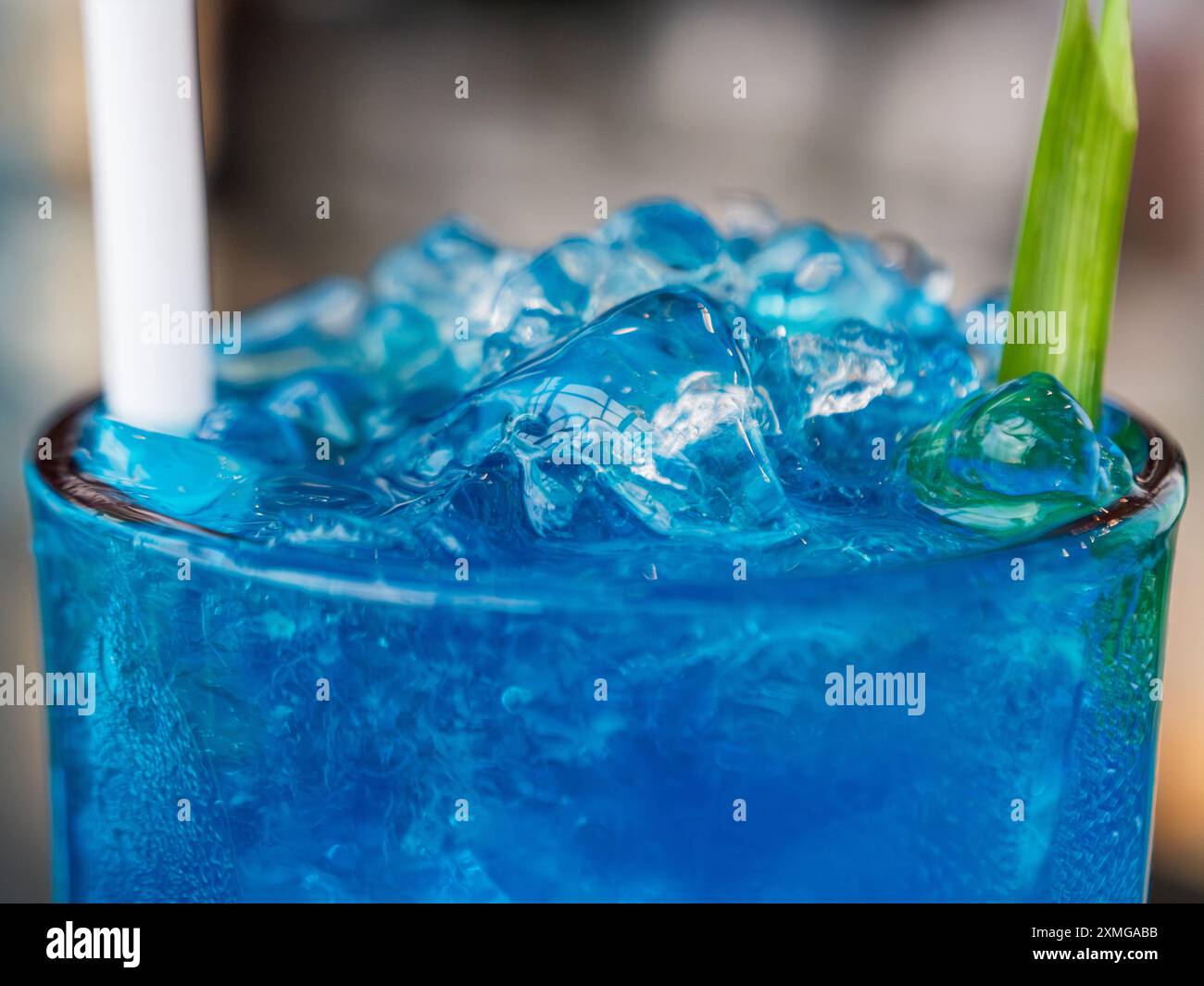 A vibrant blue drink filled with ice in a transparent glass Stock Photo ...