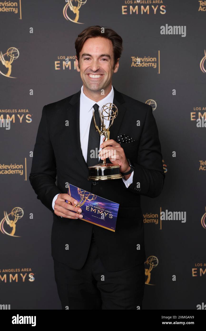 Elex Michaelson poses with the Sports Special Emmy for Athletes Who ...