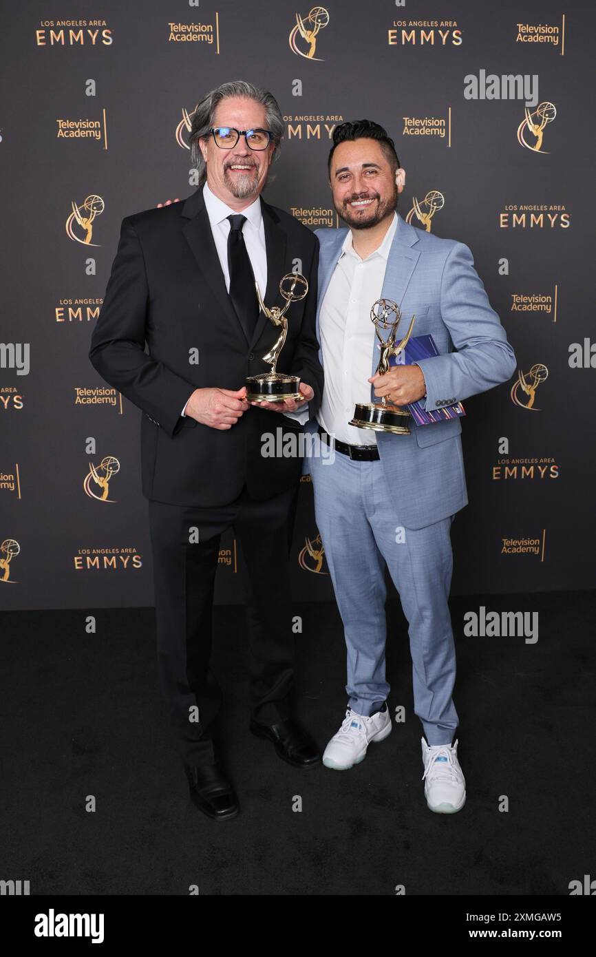 Greg Taylor and Cary Osborne pose with the Sports Feature Emmy for ...
