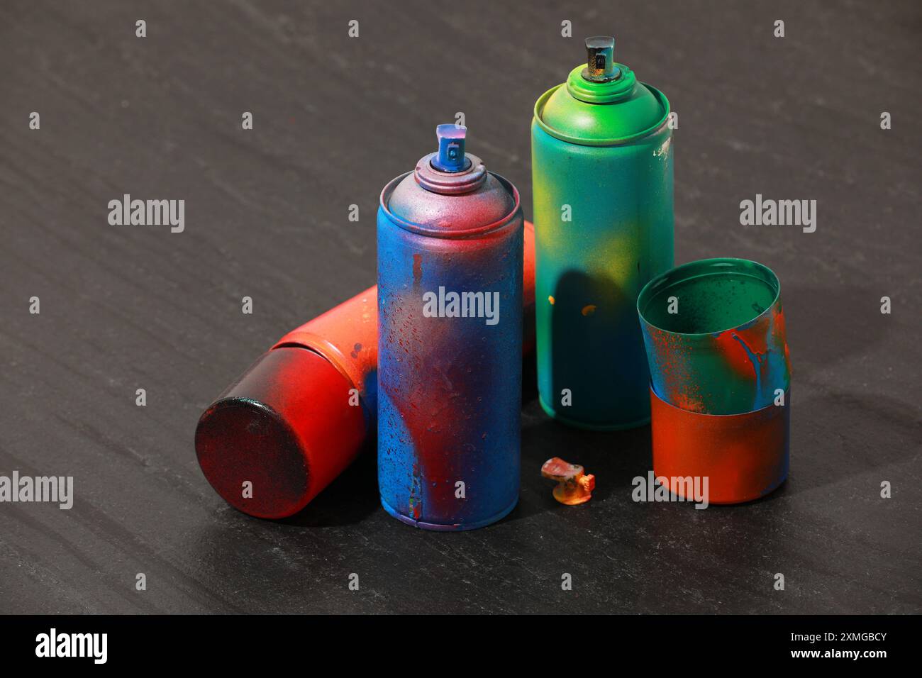 Many spray paint cans on gray textured surface Stock Photo - Alamy