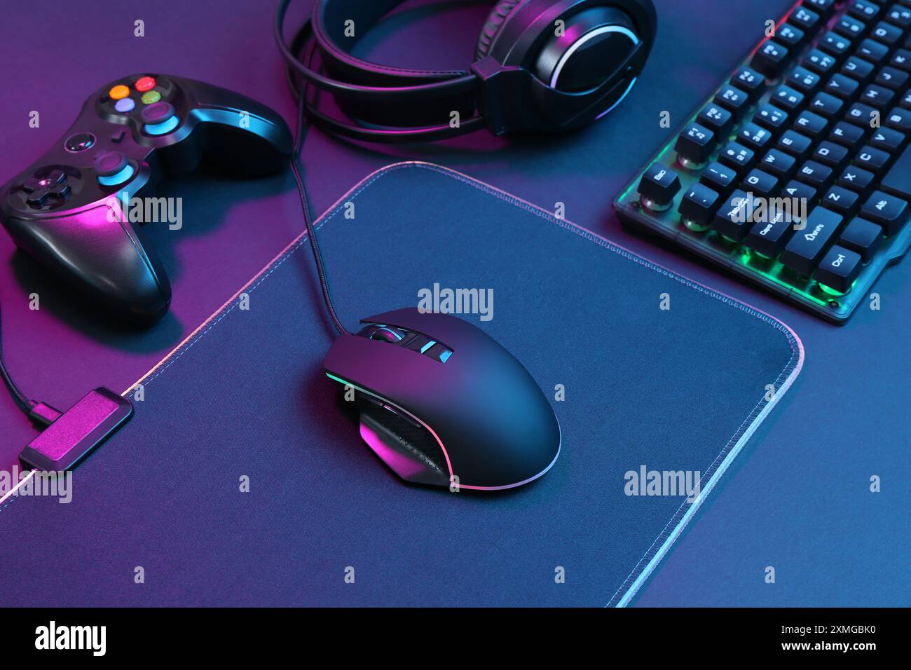 Computer mouse, RGB keyboard, game controller and headset in neon ...