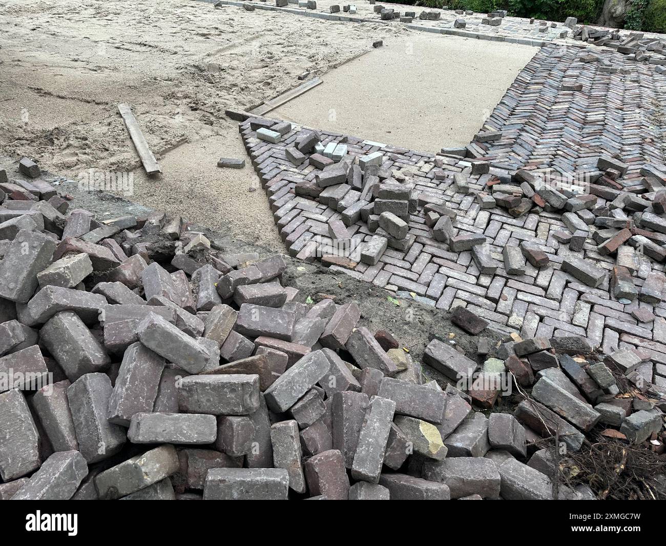 Process of laying paving stone blocks outdoors Stock Photo - Alamy