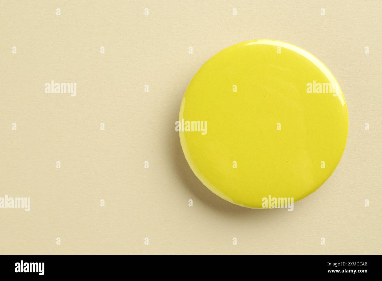 Yellow button badge on beige background. Mockup for design Stock Photo ...