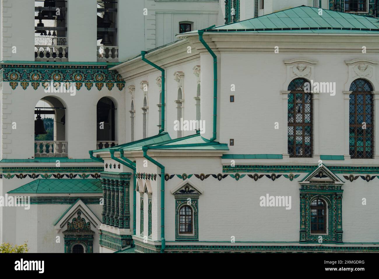 A detailed view of an ornate white building featuring green accents ...