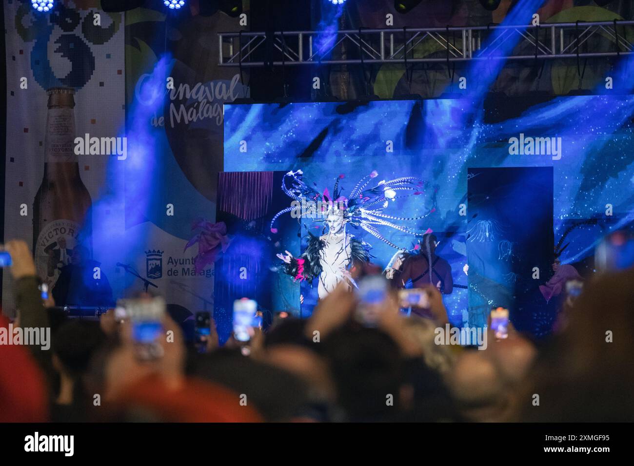 Festive event with crowd capturing illuminated stage performance on ...