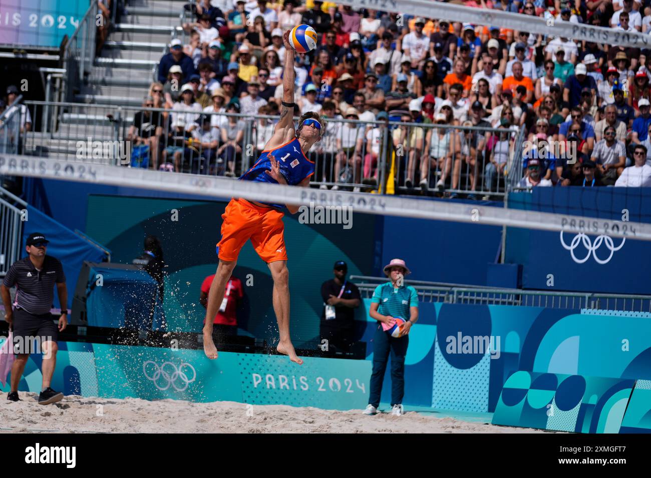 The Netherland's Steven van de Velde serves in a beach volleyball match ...