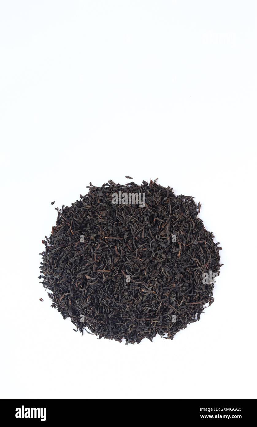 Black long tea on a white background. Top view of dried tea leaves. Tea ...