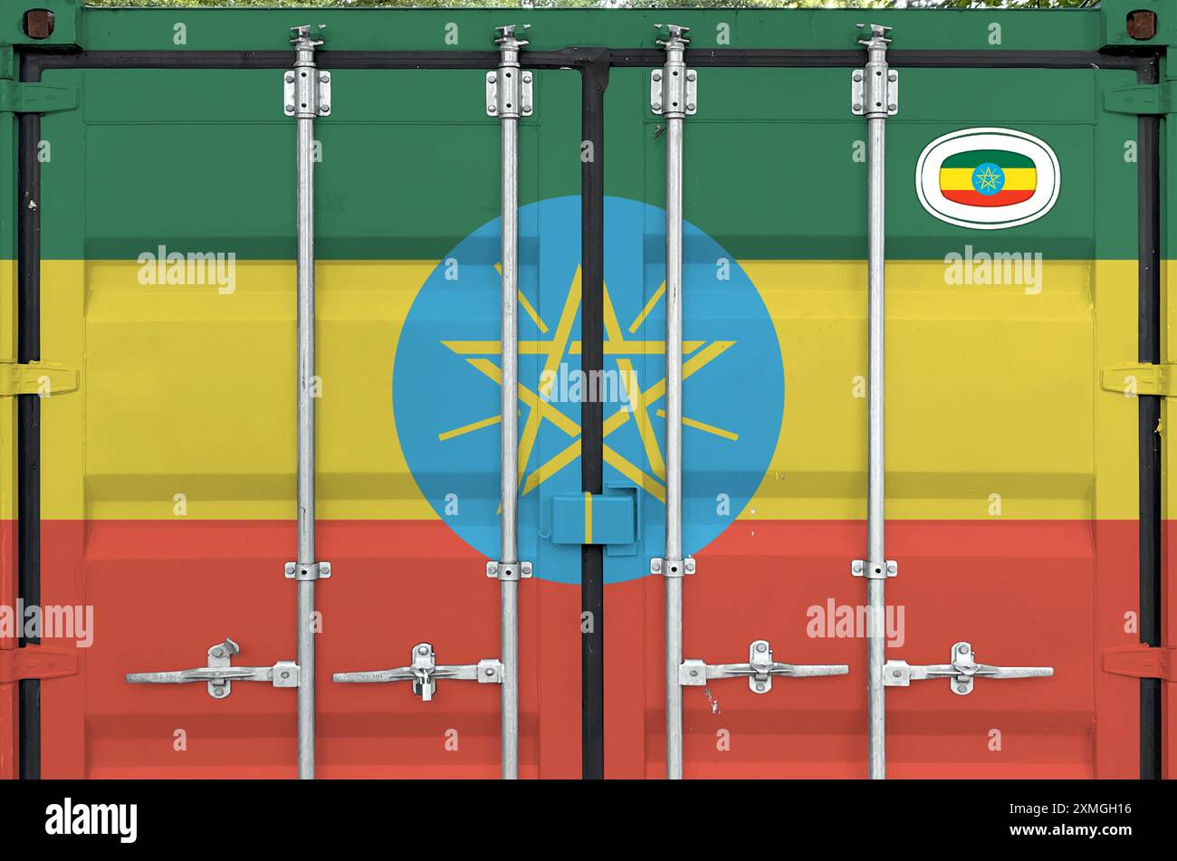 Ethiopia flag depicted on metal doors of shipping cargo container outdoors in docks area close ...