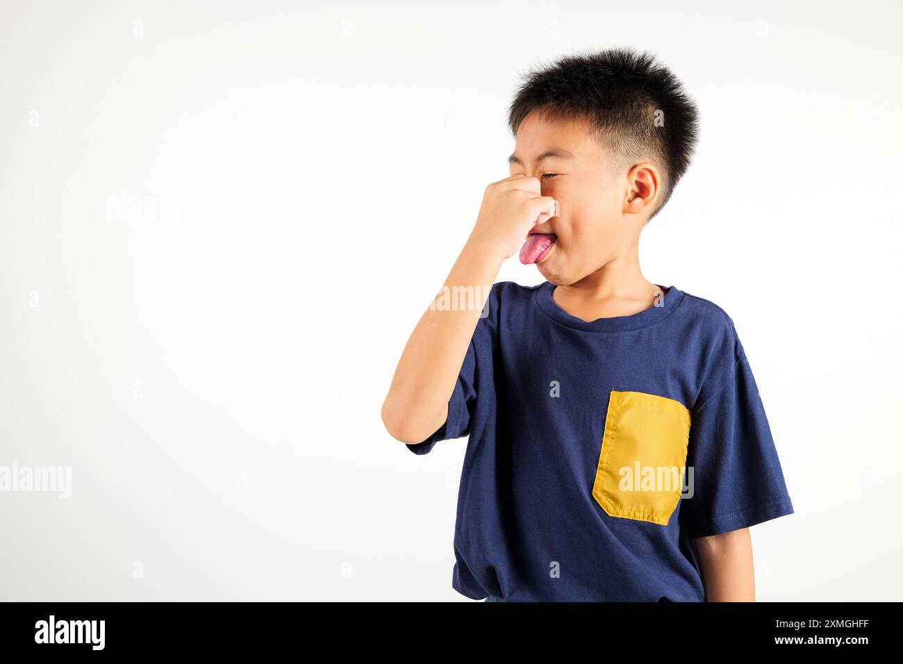 Asian young child unhappy what a smell disgust expression squeezing ...