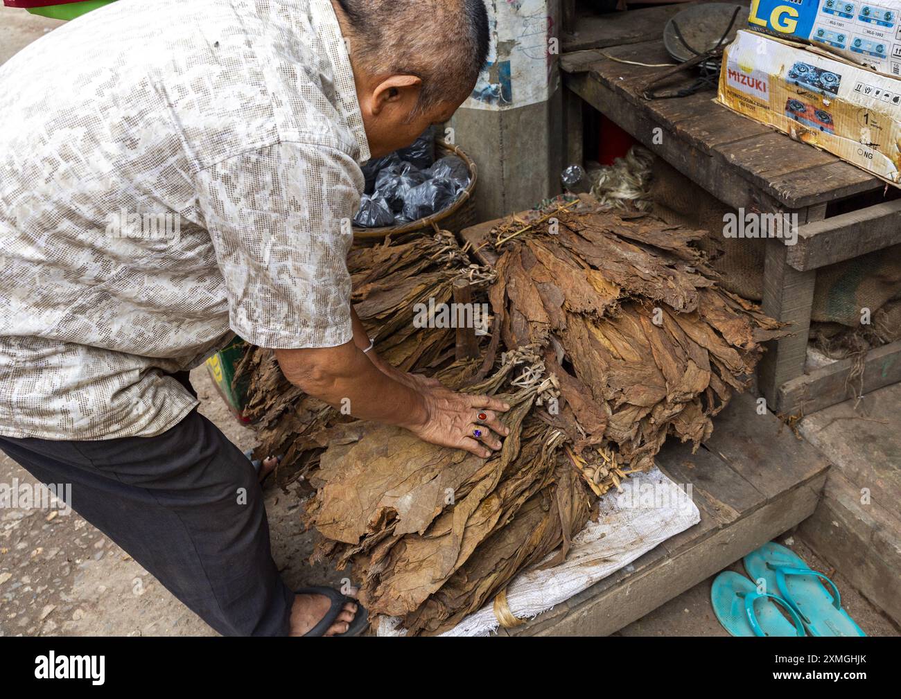 Bangladeshi man selling dried tobacco leaves at Chakma tribe market ...