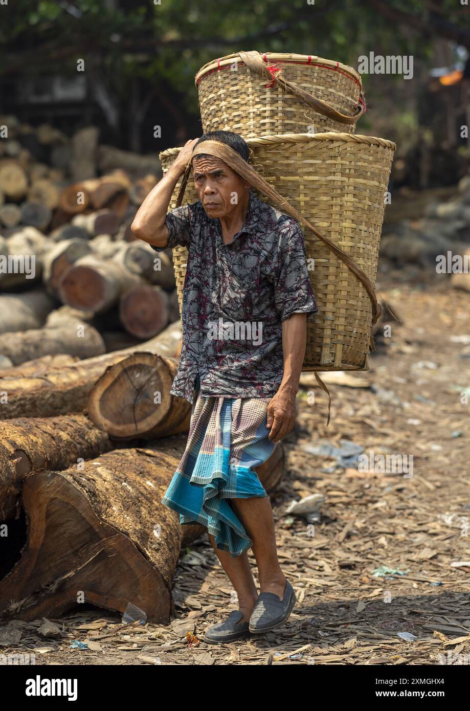 Chakma tribe man carrying heavy baskets, Chittagong Division, Rangamati ...