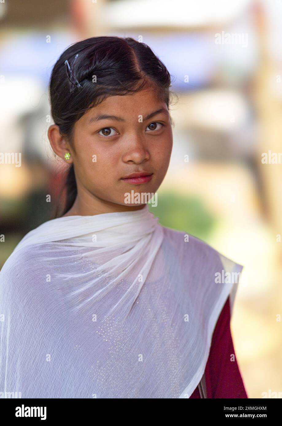 Portrait of a bangladeshi Chakma tribe teenage girl wearing white sari ...