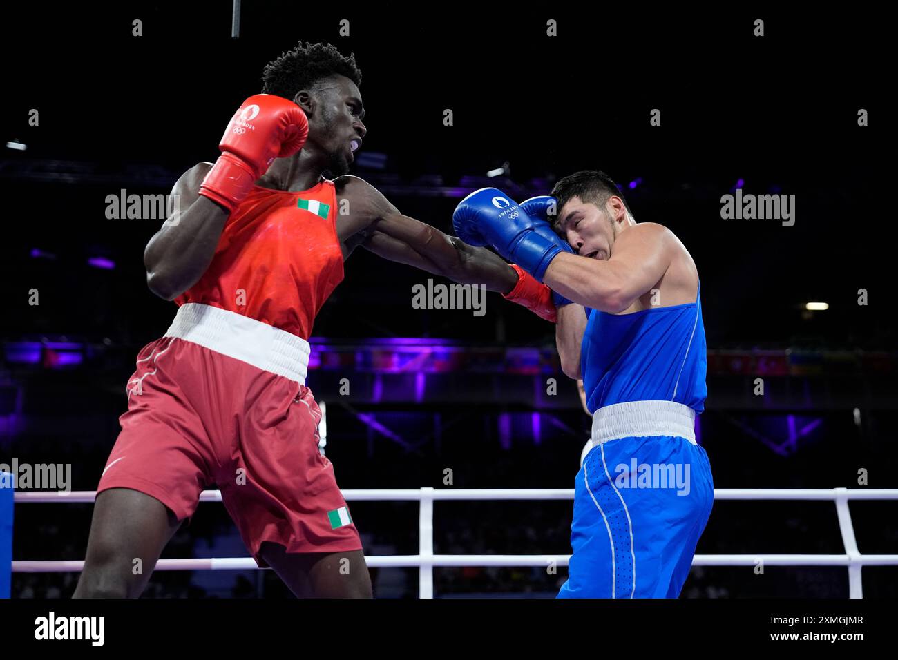 Nigeria's Olaitan Olaore, left, fights, Kazakhstan's Aibek ...