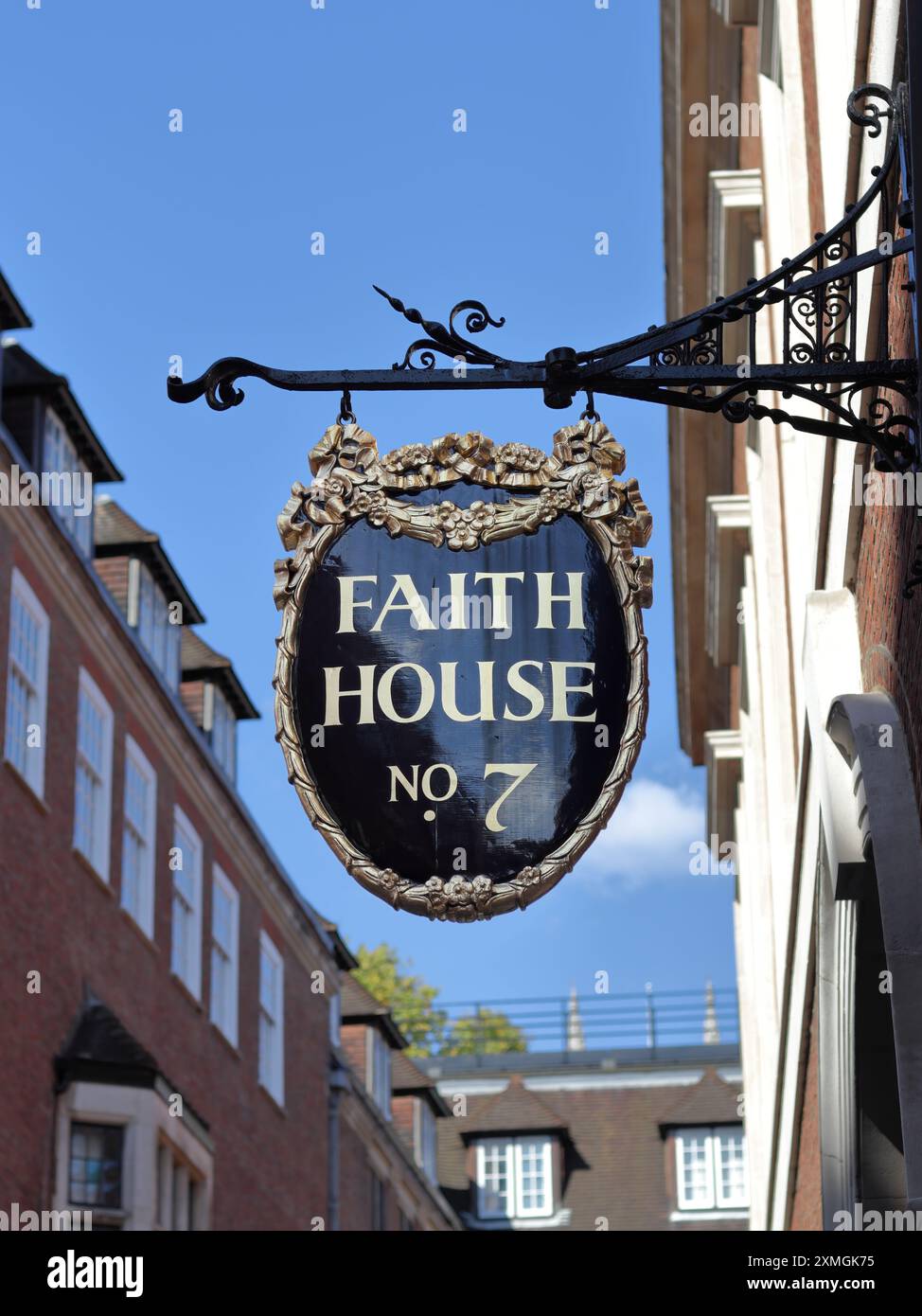 Hanging street sign of the Faith House in Tuffon street, London ...