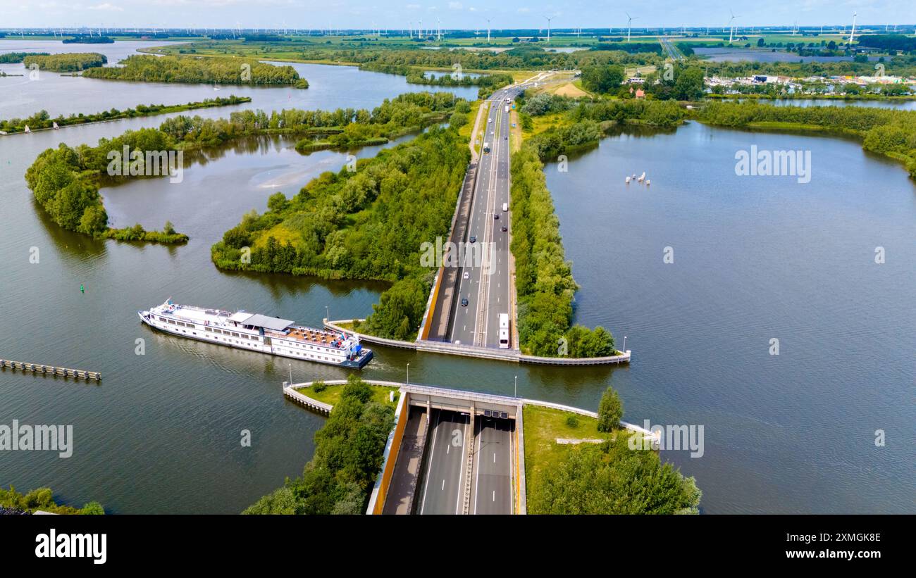 A cruise ship navigates the Aquaduct Veluwemeer in the Netherlands, a ...