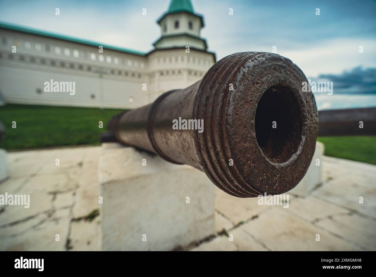 old, rusty cannon aimed directly at the camera, with a historical ...