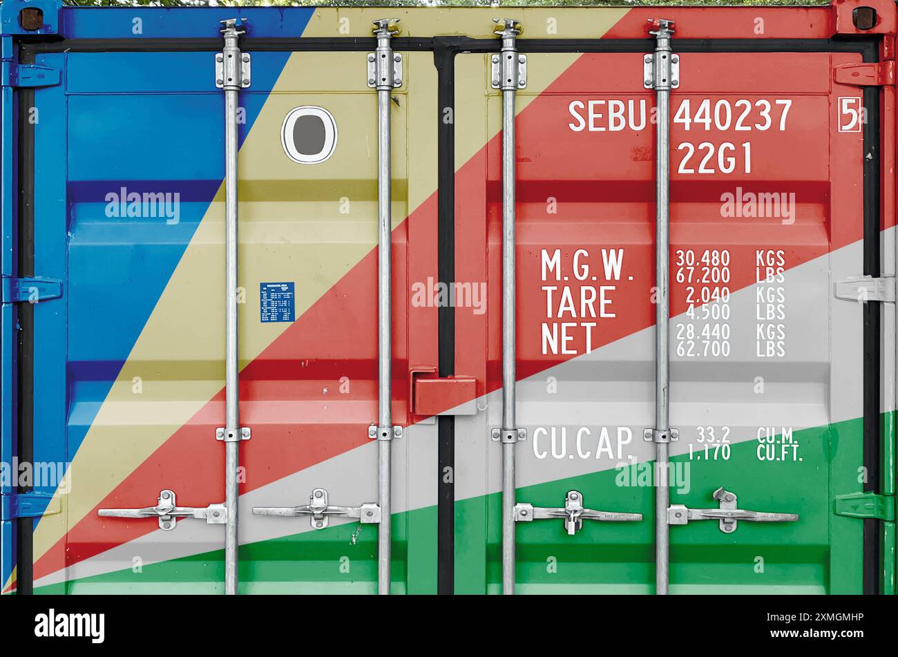 Seychelles flag depicted on metal doors of shipping cargo container outdoors in docks area close ...