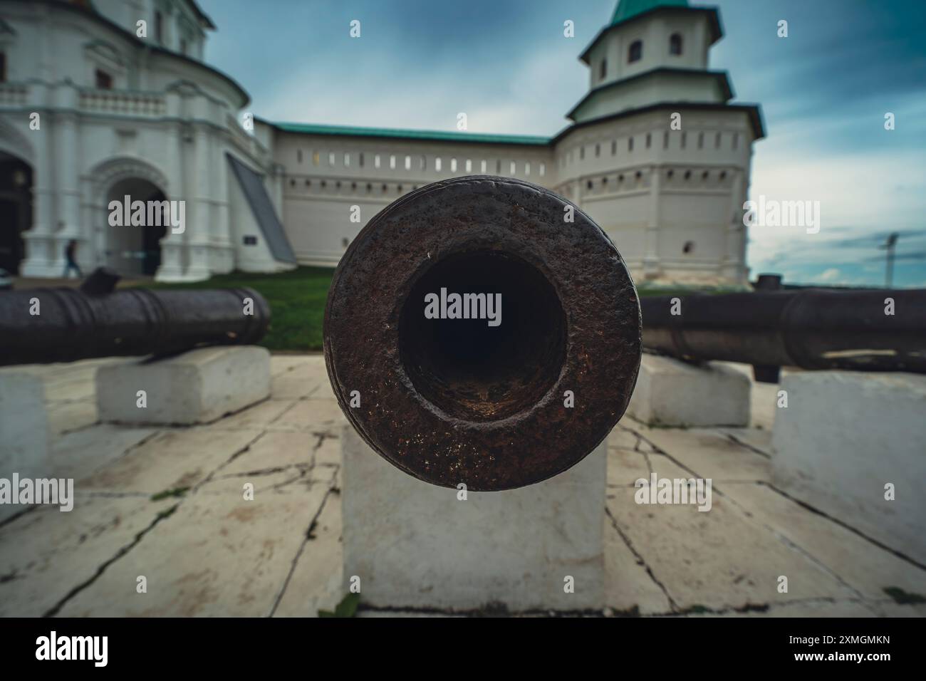 old, rusty cannon aimed directly at the camera, with a historical ...