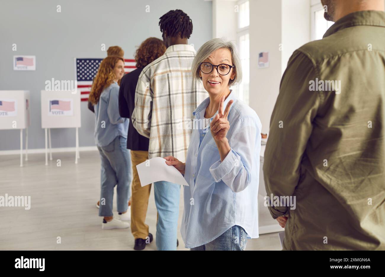 American voter woman registering at polling station on election day at ...