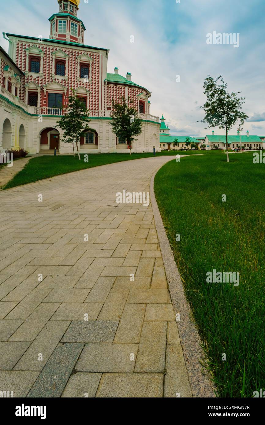 A paved pathway leading to a historic building featuring a distinctive ...