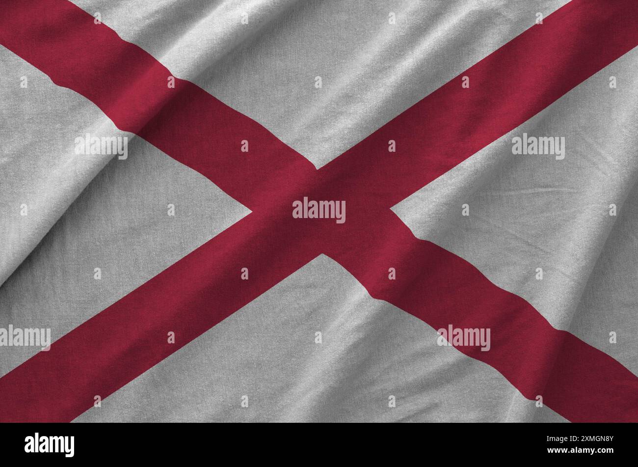 Alabama US state flag depicted on folded wavy fabric of old cloth close ...