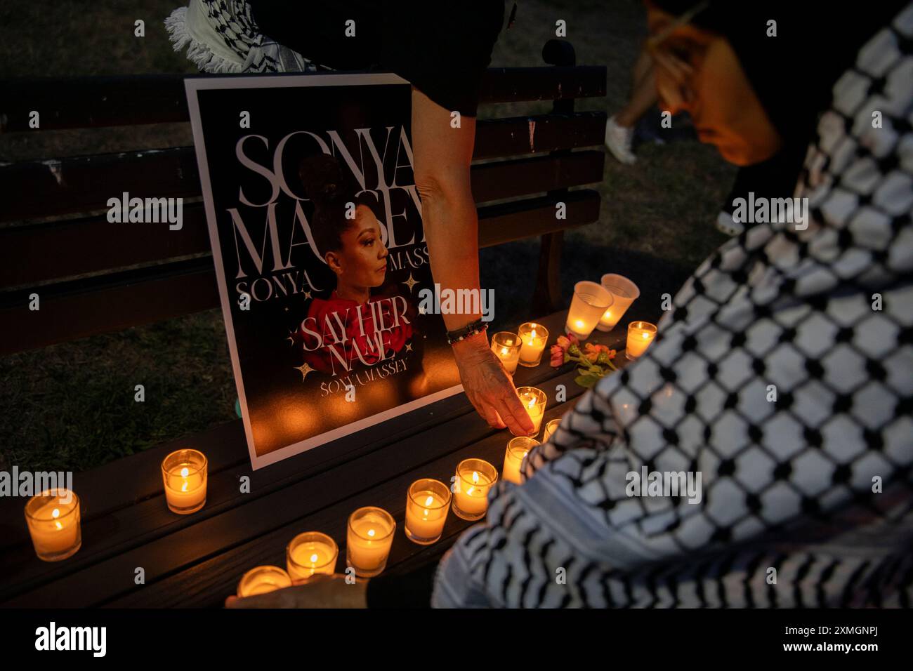 Mourners put up candles while attending a vigil for Sonya Massey in ...