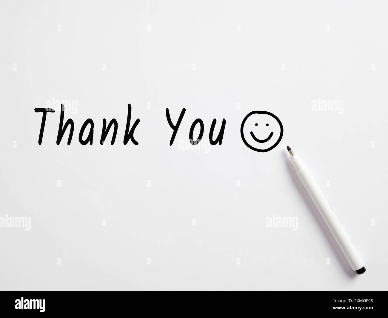 Hand written thank you message on white background wit a smiling ...
