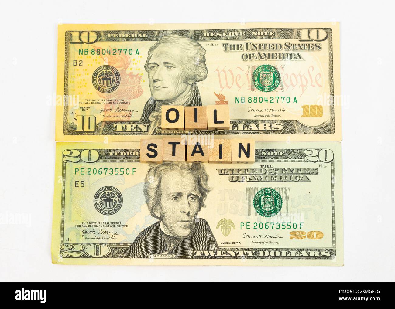 Ten and Twenty-Dollar Bills with Oil Stains and Wooden Blocks Spelling ...