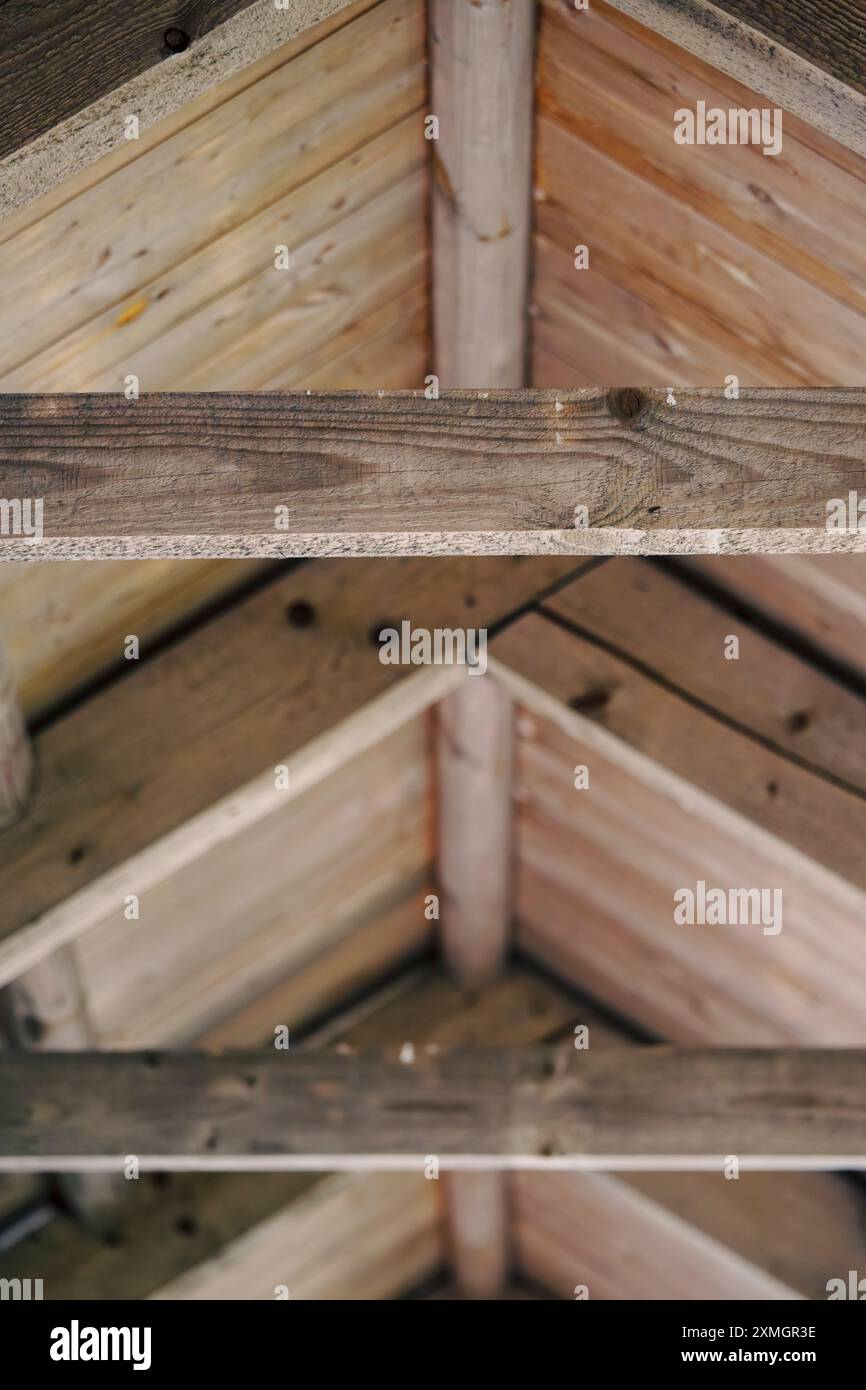 Close-up view of the wooden beams and planks forming the roof structure ...