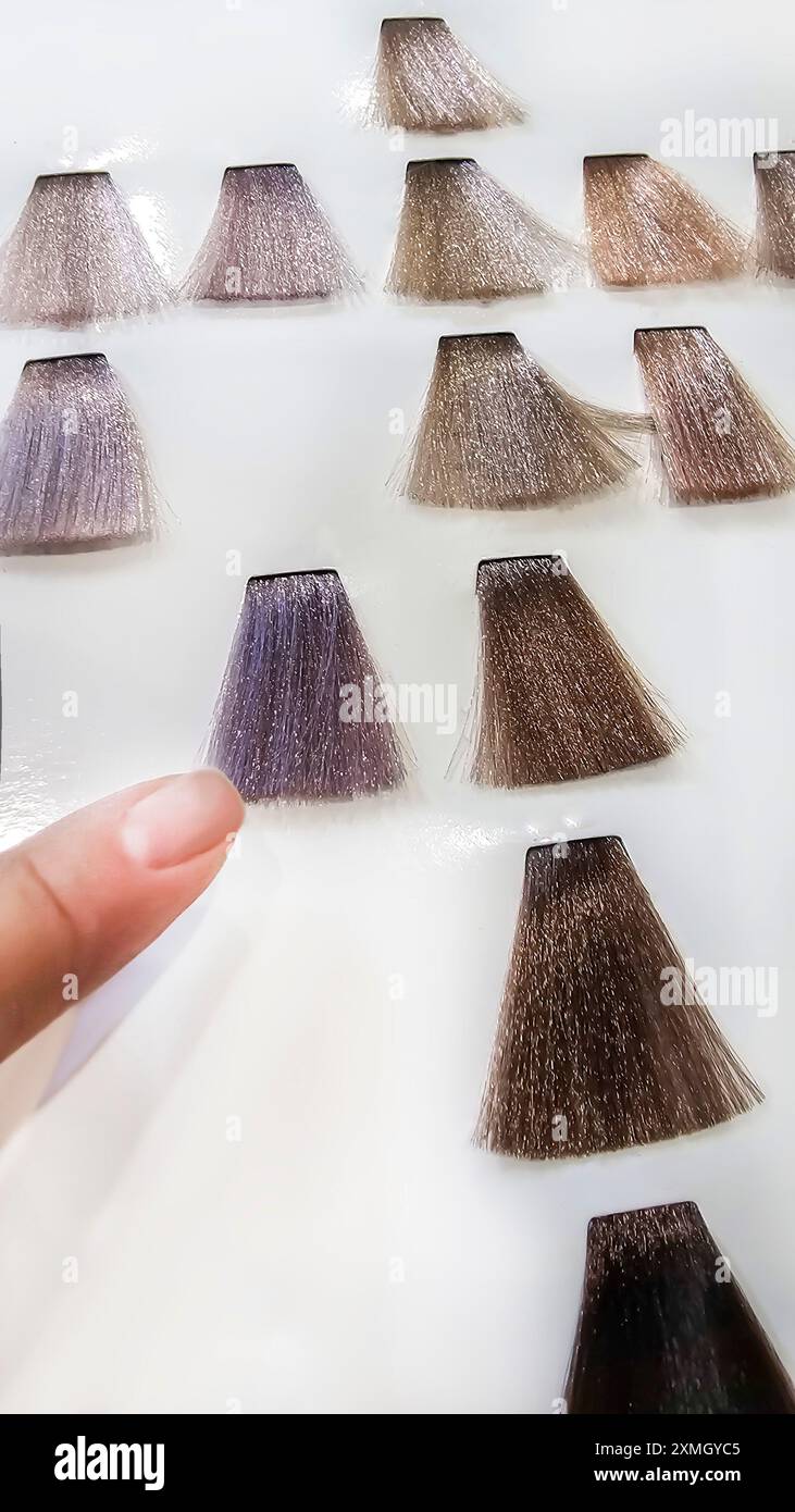 A palette of hair colors made from artificial strands on a white ...
