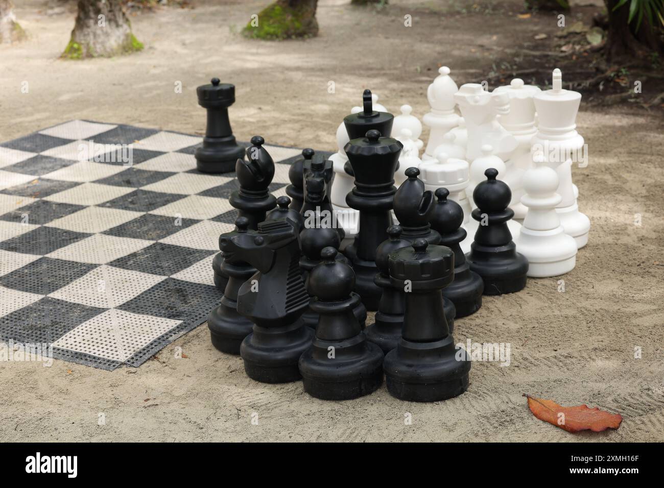 Giant chess on the board located on the ground Stock Photo - Alamy