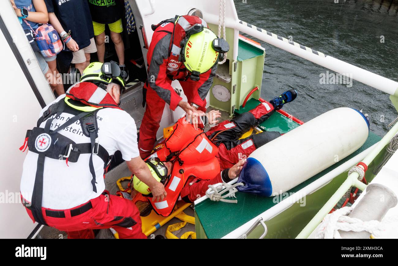 28 July 2024, Schleswig-Holstein, Grömitz: Maritime rescuers pull a man ...