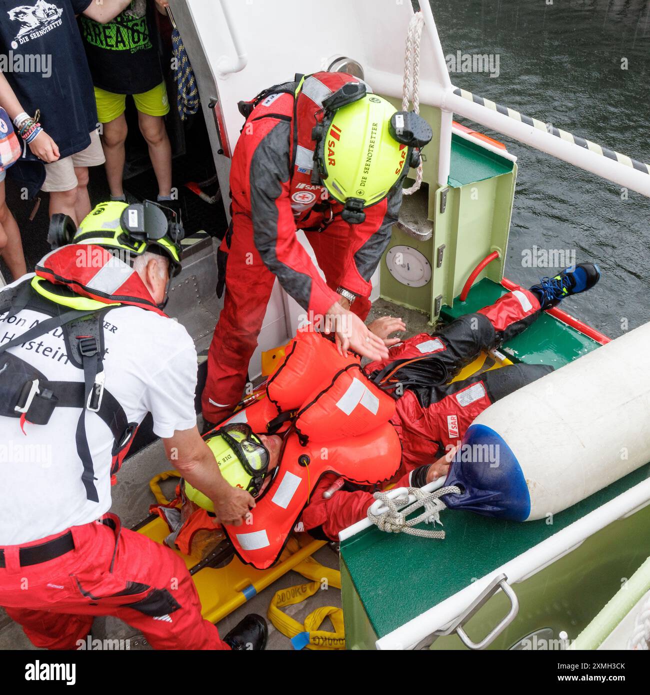 28 July 2024, Schleswig-Holstein, Grömitz: Maritime rescuers pull a man ...