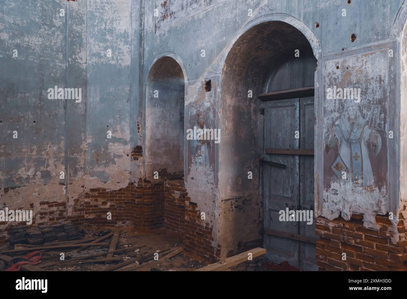The interior of an abandoned church featuring decaying walls, broken ...