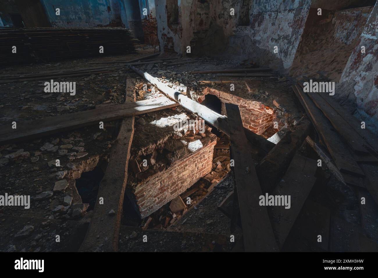 An interior view of an abandoned church featuring a collapsed floor ...
