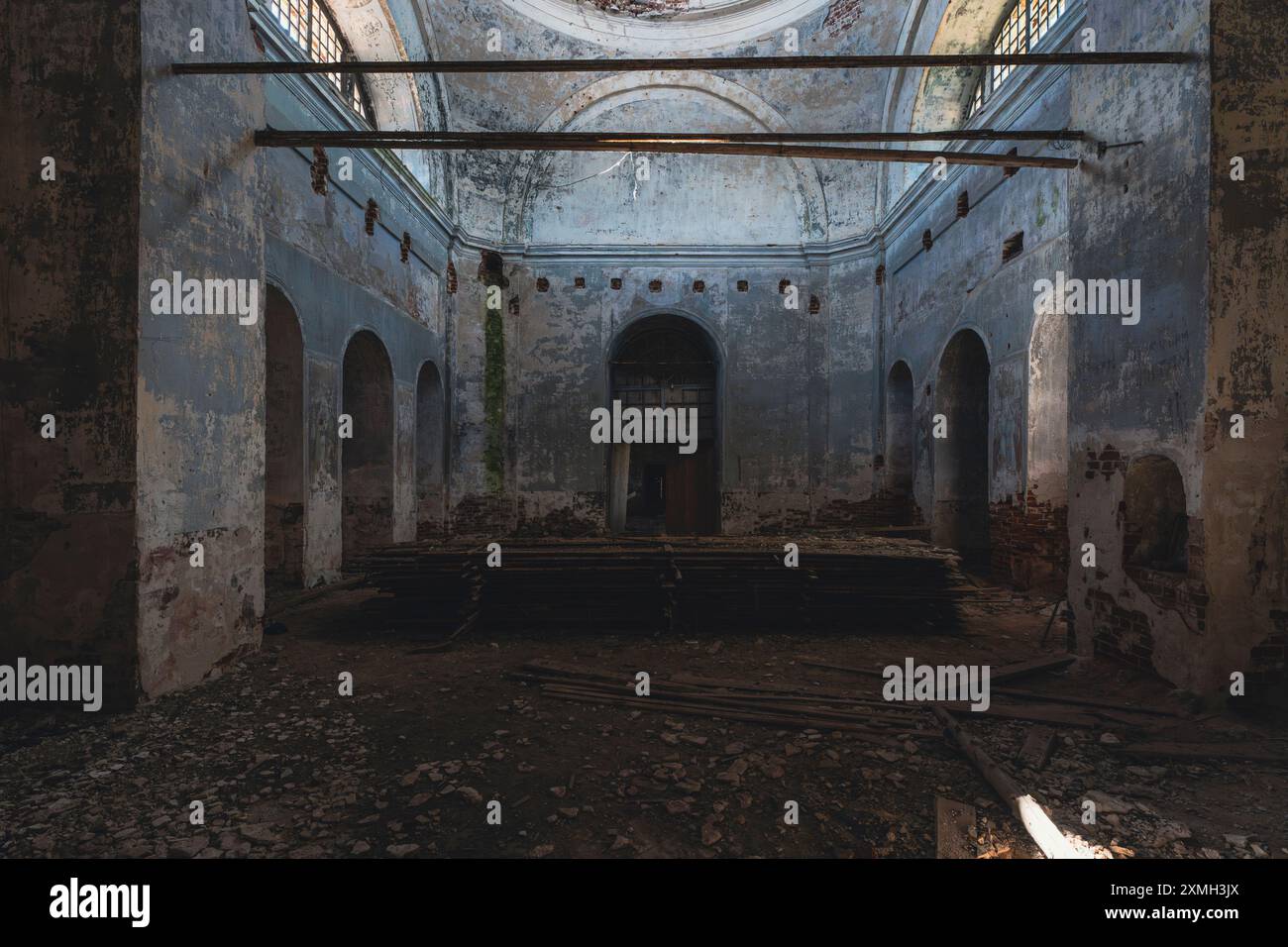 The interior of an abandoned church featuring decaying walls, broken ...