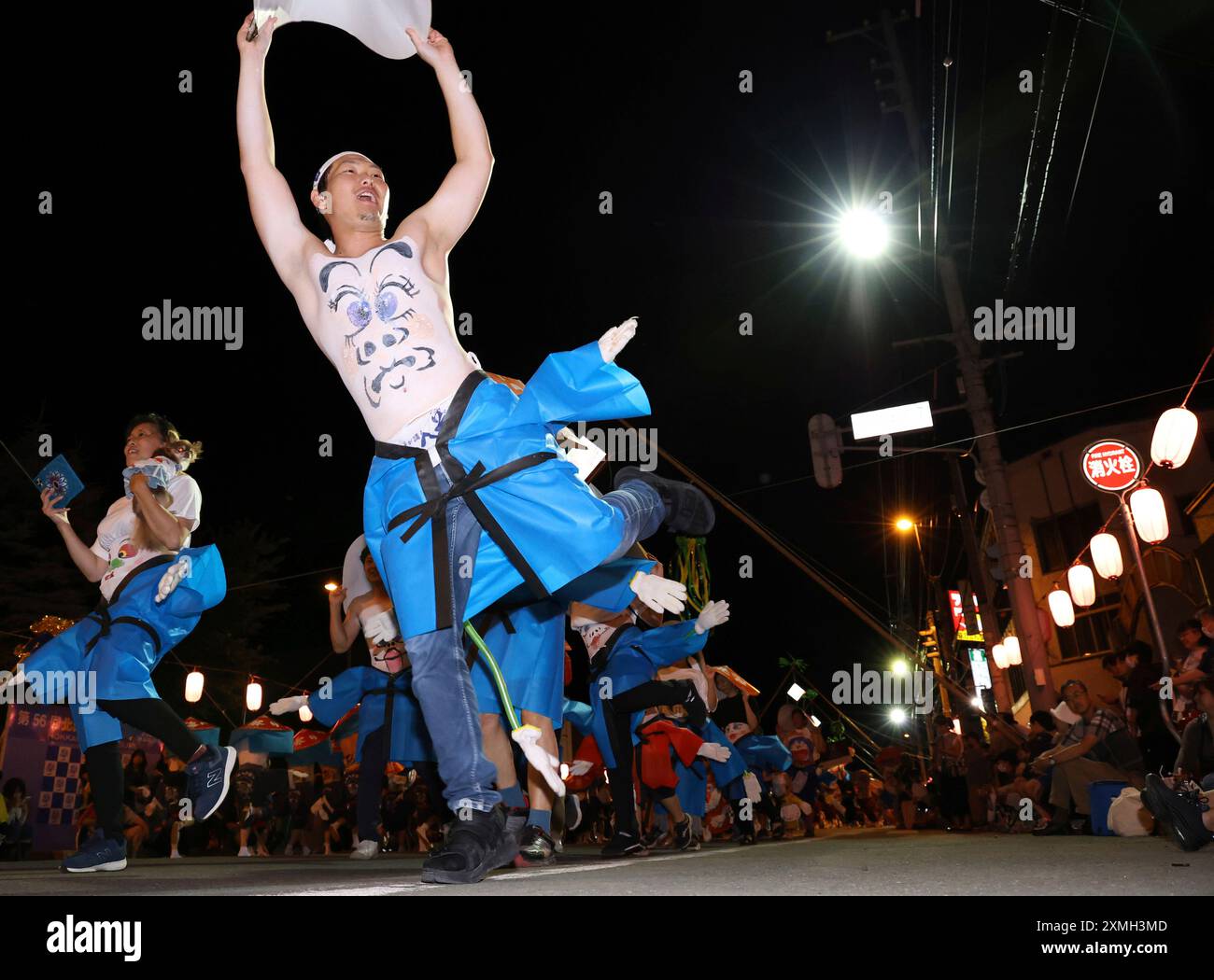 People perform the belly button dance during the Hokkai Belly Button Festival in Furano City ...