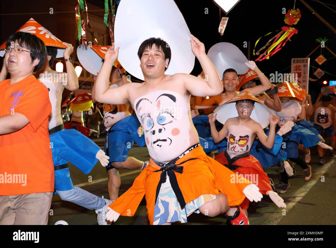 People perform the belly button dance during the Hokkai Belly Button Festival in Furano City ...