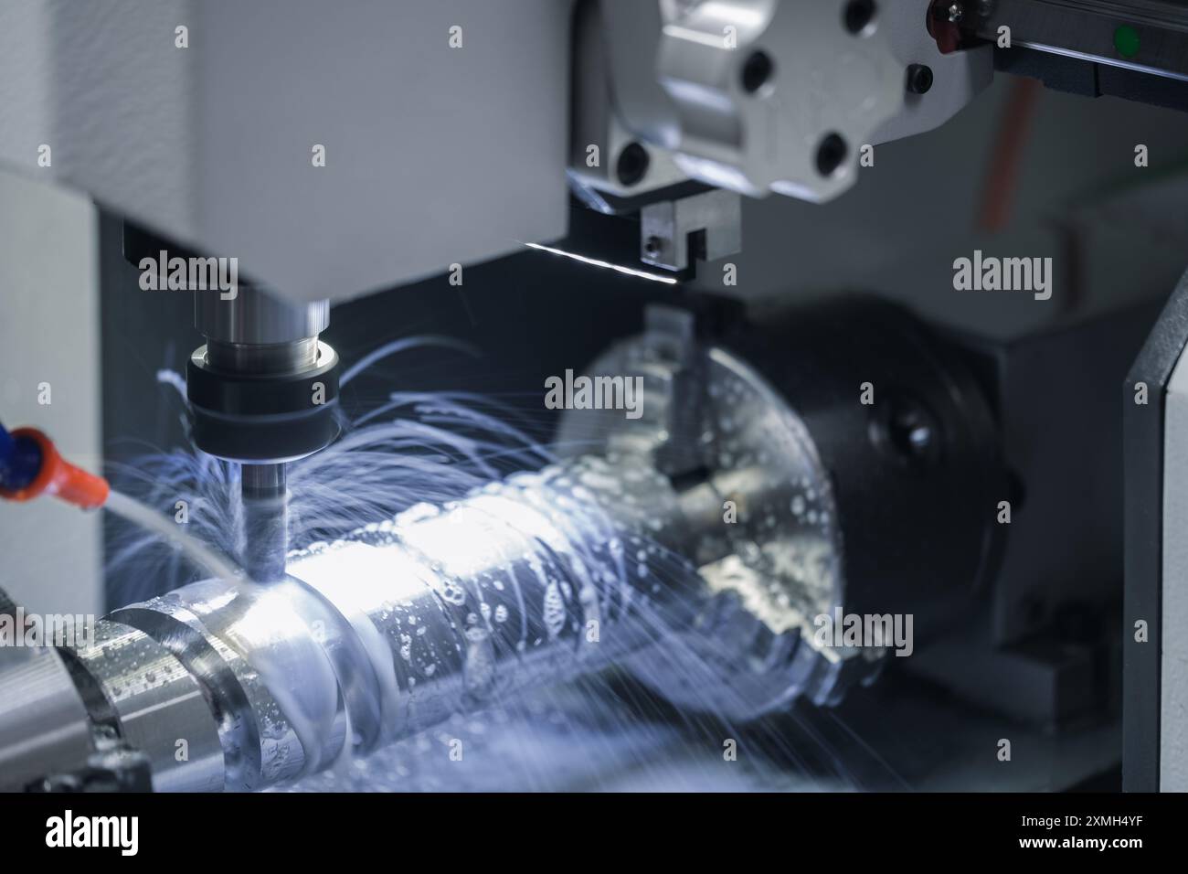 A modern cnc machine produces a piece of metal part using the milling ...