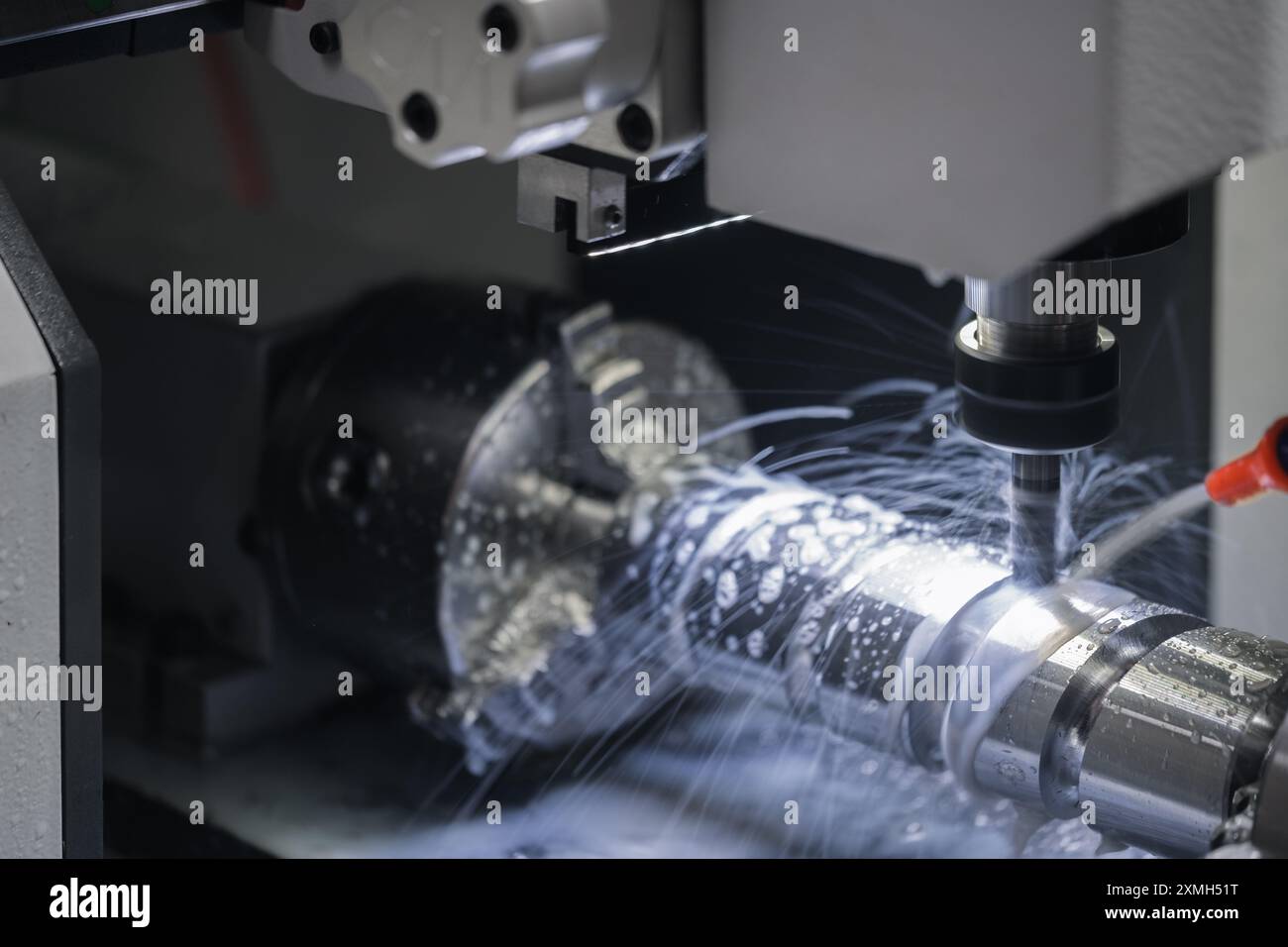 A modern cnc machine produces a piece of metal part using the milling ...