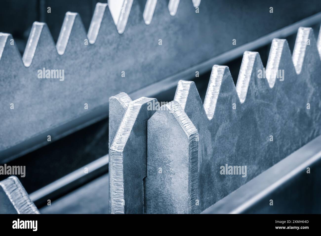 A row of metal sheets with sharp ends in an industrial plant. The ...