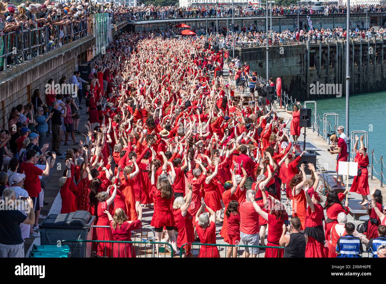 Dancers in red dresses on Folkestone's Harbour Arm for Kate Bush Day ...